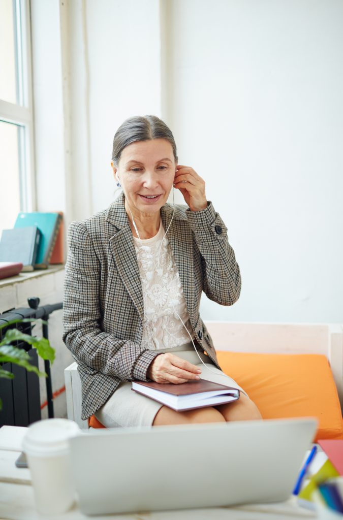 Mature Employee Working in Office Lobby - Karen Commins